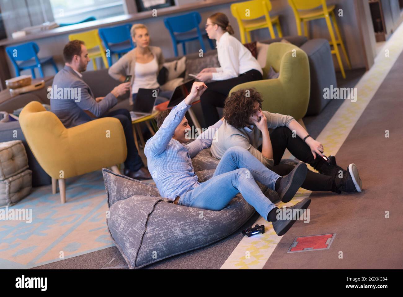 Work hard play hard. Workers Playing computer games in creative startup ...