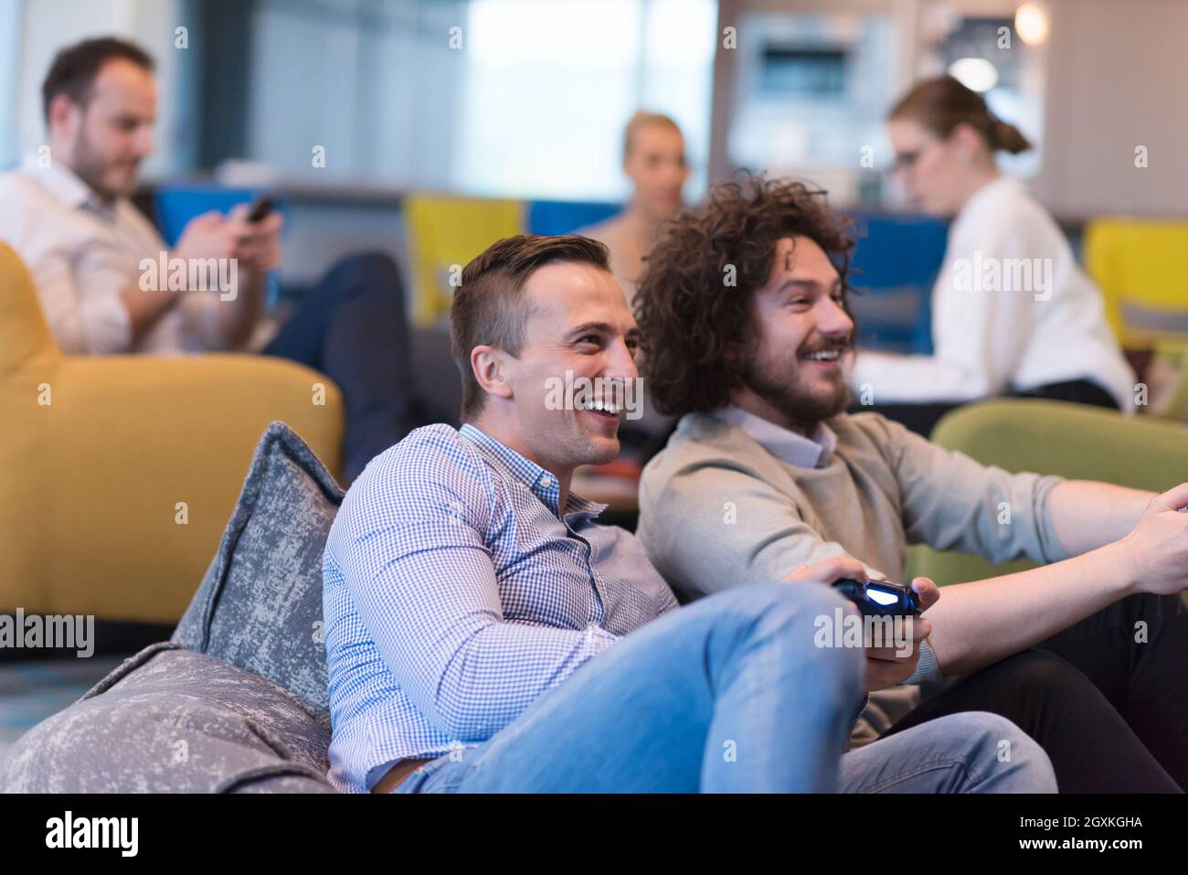 Work hard play hard. Workers Playing computer games in creative startup ...