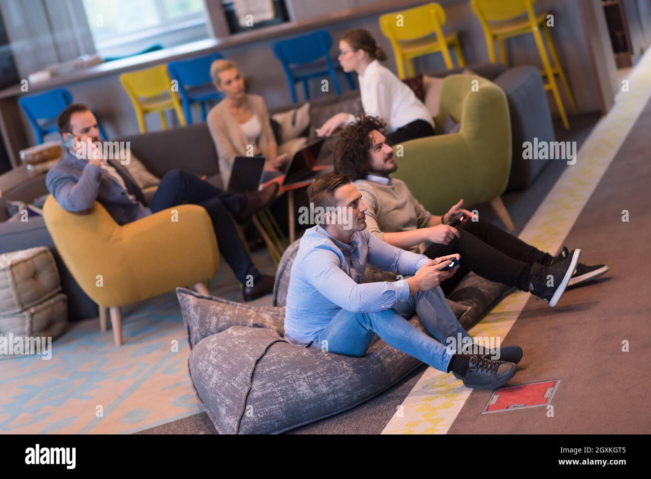 Work hard play hard. Workers Playing computer games in creative startup ...