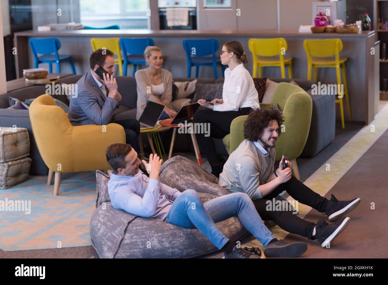 Work hard play hard. Workers Playing computer games in creative startup ...