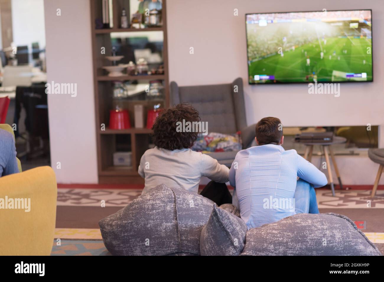 Work hard play hard. Workers Playing computer games in creative startup ...