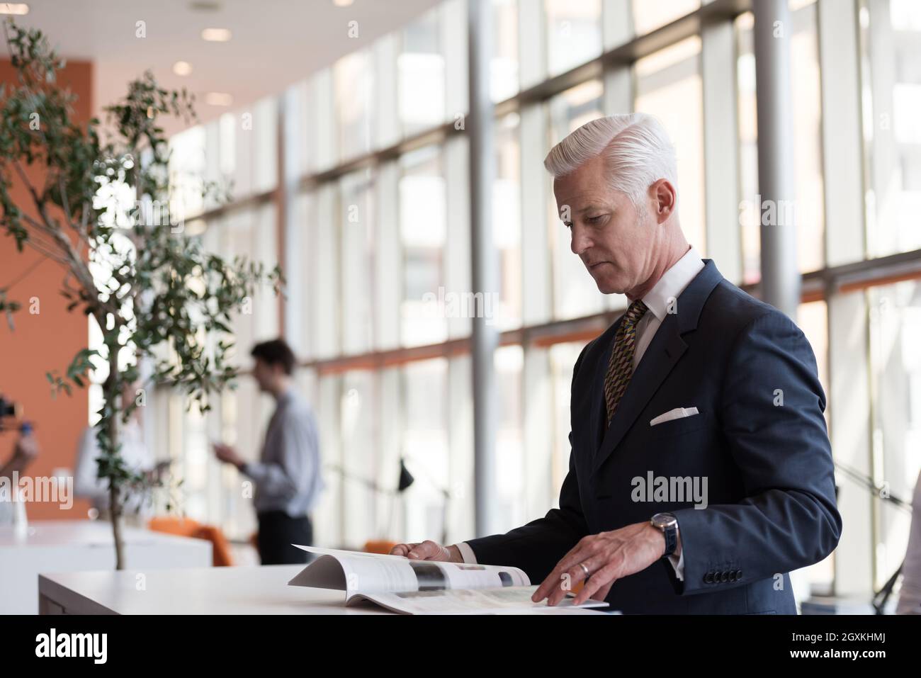 senior business man reading magazine at modern bright office Stock ...