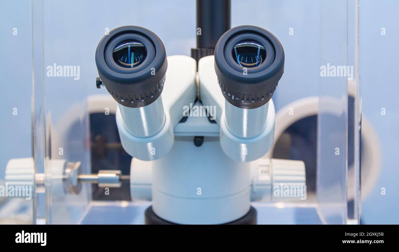 The eyepieces of a light or fluorescent microscope in a research ...