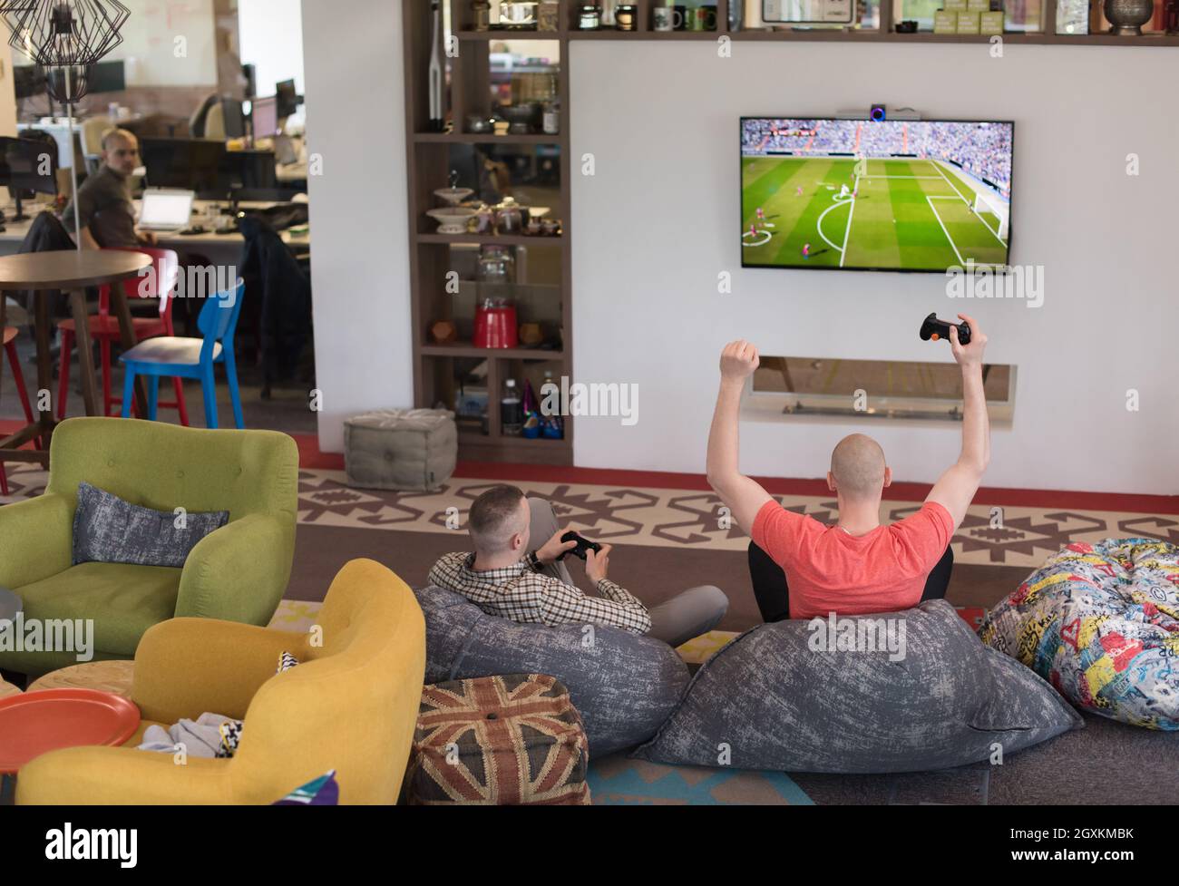 Work hard play hard. Workers Playing computer games in creative startup ...