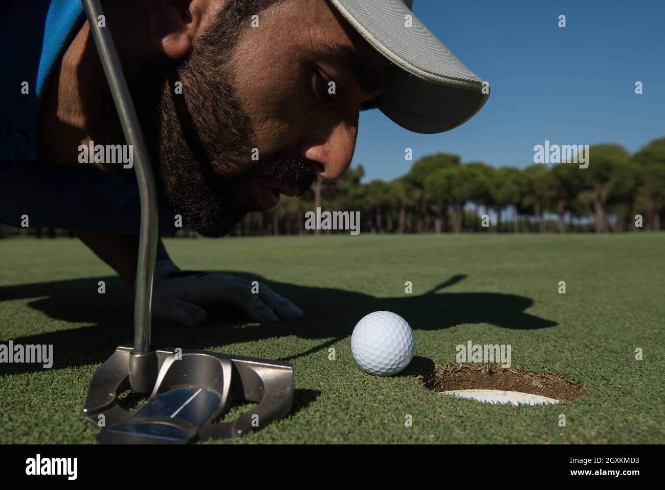 golf player blowing ball in hole. concept of cheating and success Stock ...