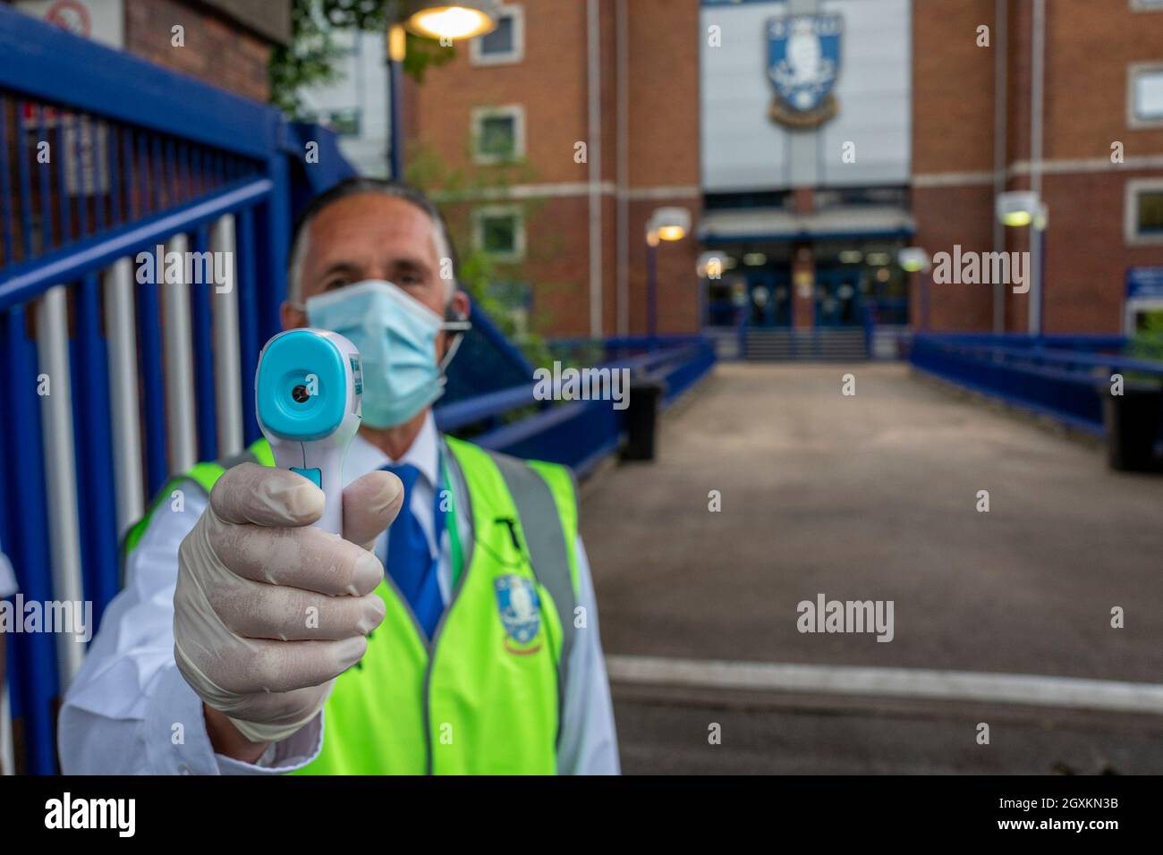 A security guard checks temperatures before entering Hillsborough ...