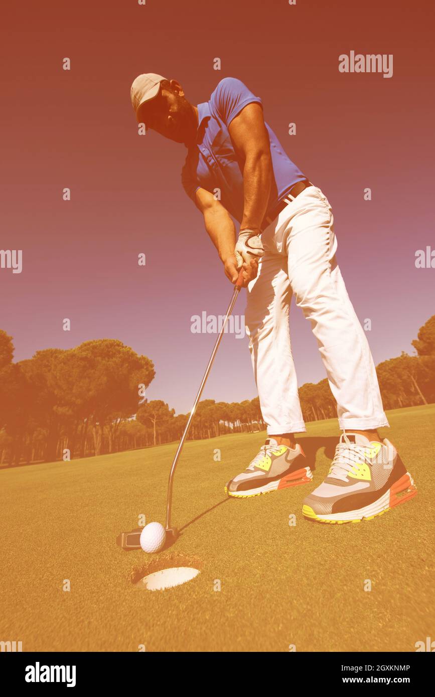 golf player hitting shot with driver on course at beautiful sunny day ...