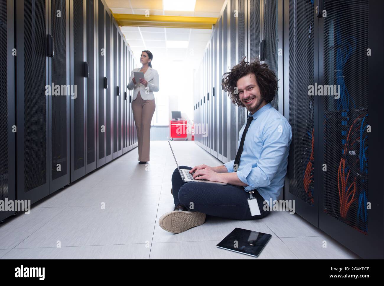 Team of young technicians working together on servers at the data ...