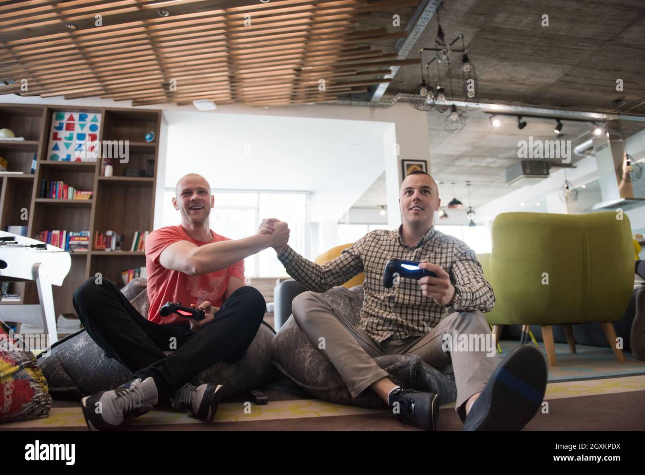 Work hard play hard. Workers Playing computer games in creative startup ...