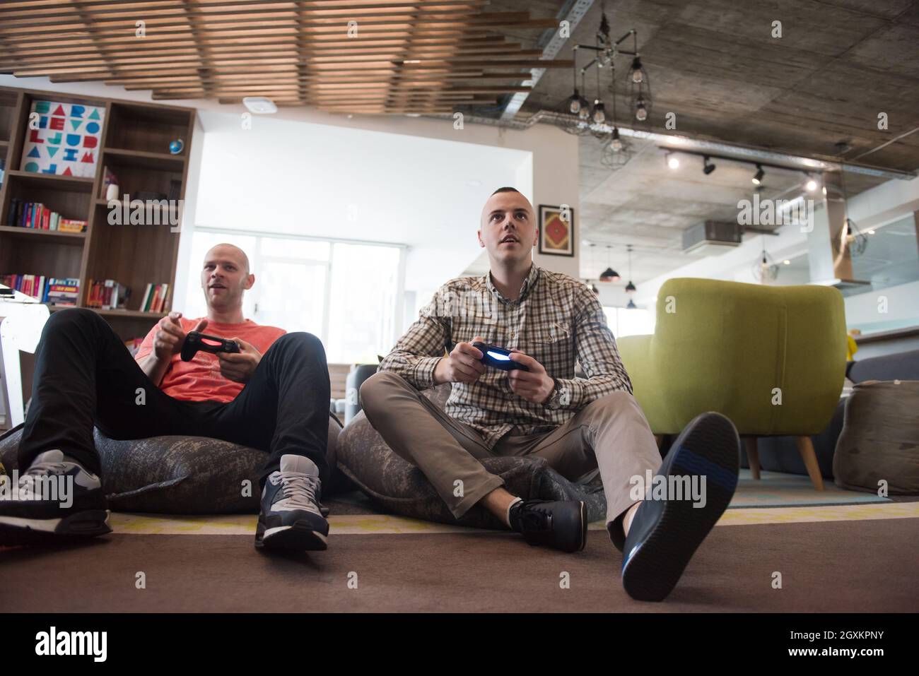 Work hard play hard. Workers Playing computer games in creative startup ...