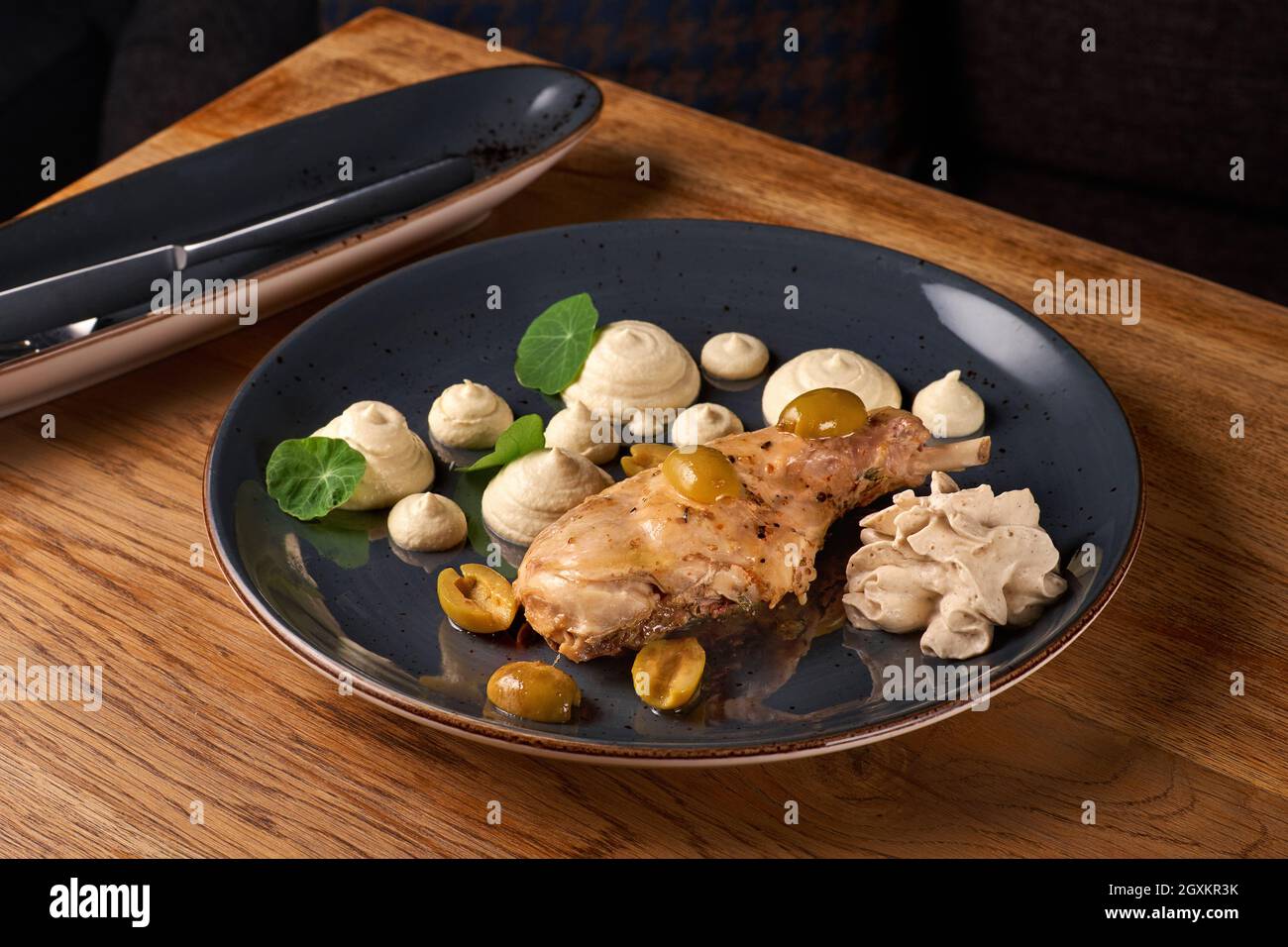 Tasty spicy rabbit stew in tomato sauce with white wine and herbs close ...