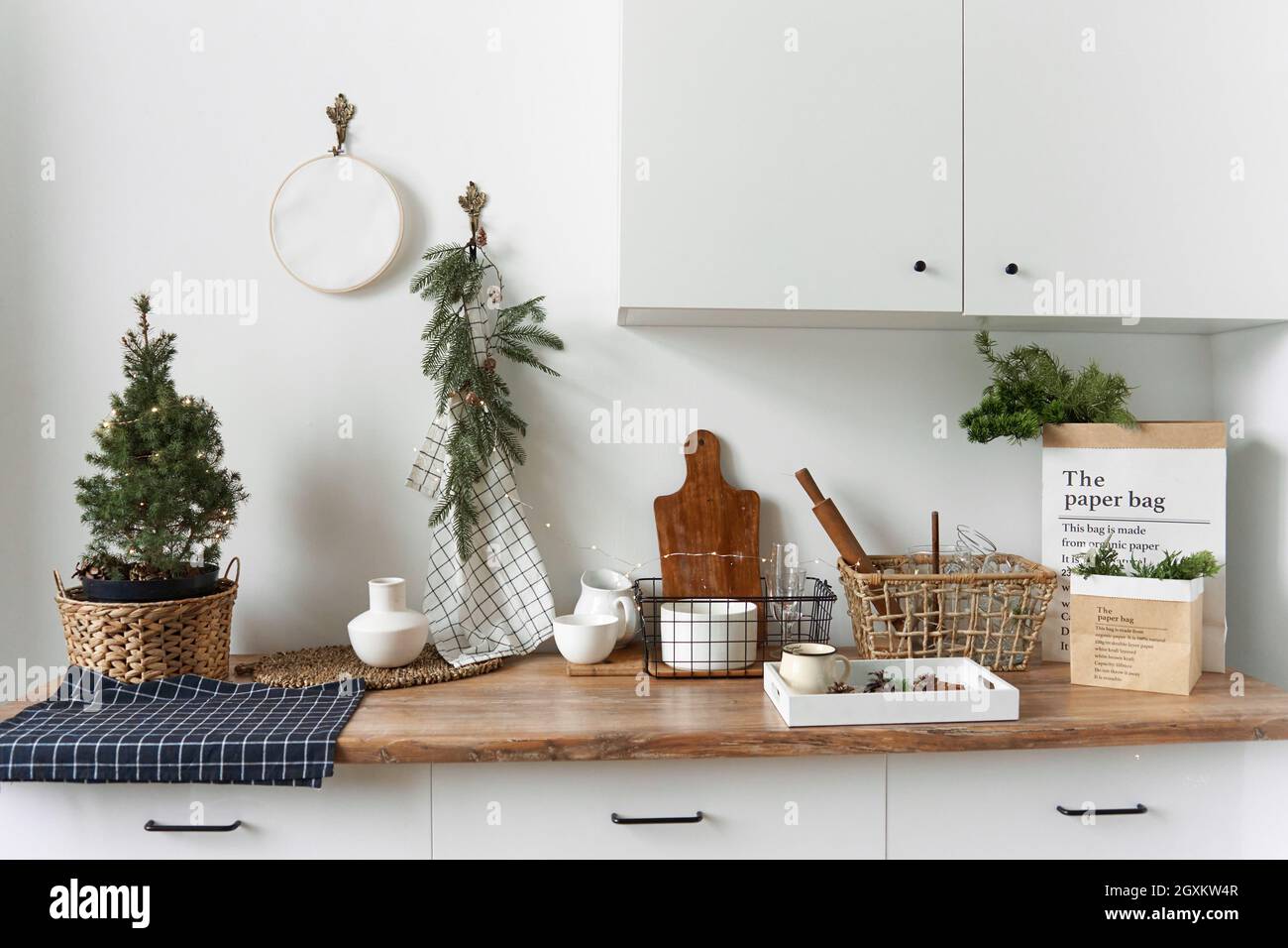 Minimalistic light kitchen interior using pine branches Stock Photo - Alamy