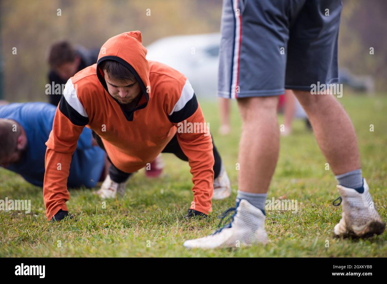 american football team doing push ups during training at the field ...