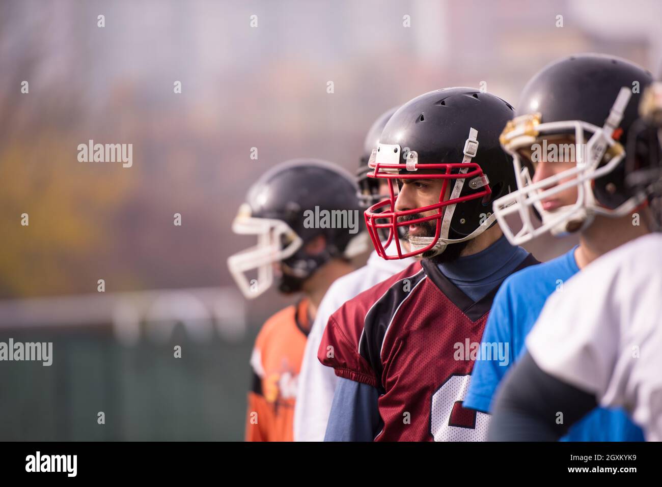 portrait of young american football team standing one behind the other ...