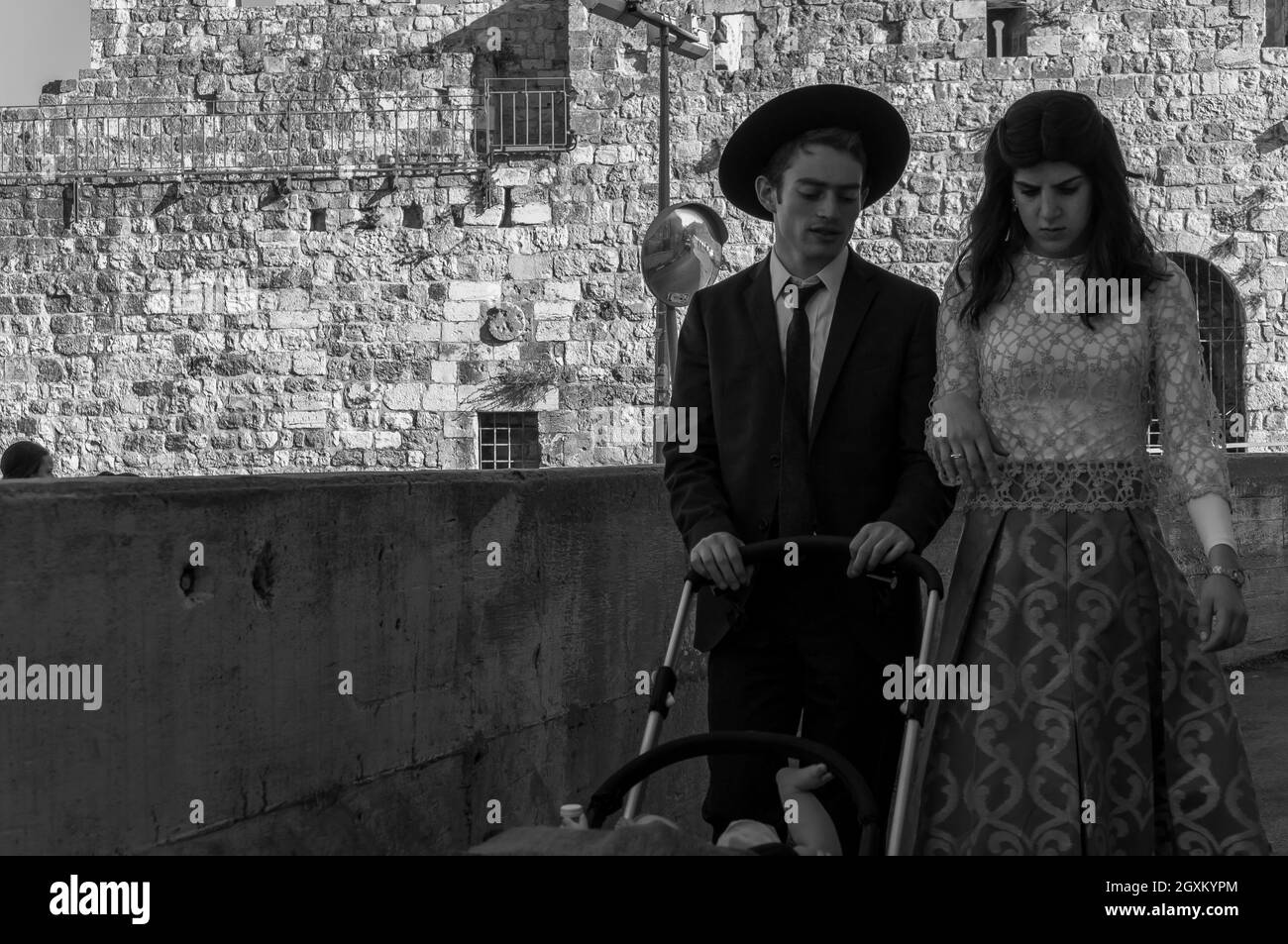 Orthodox Jewish family in traditional clothing on the street of the old ...