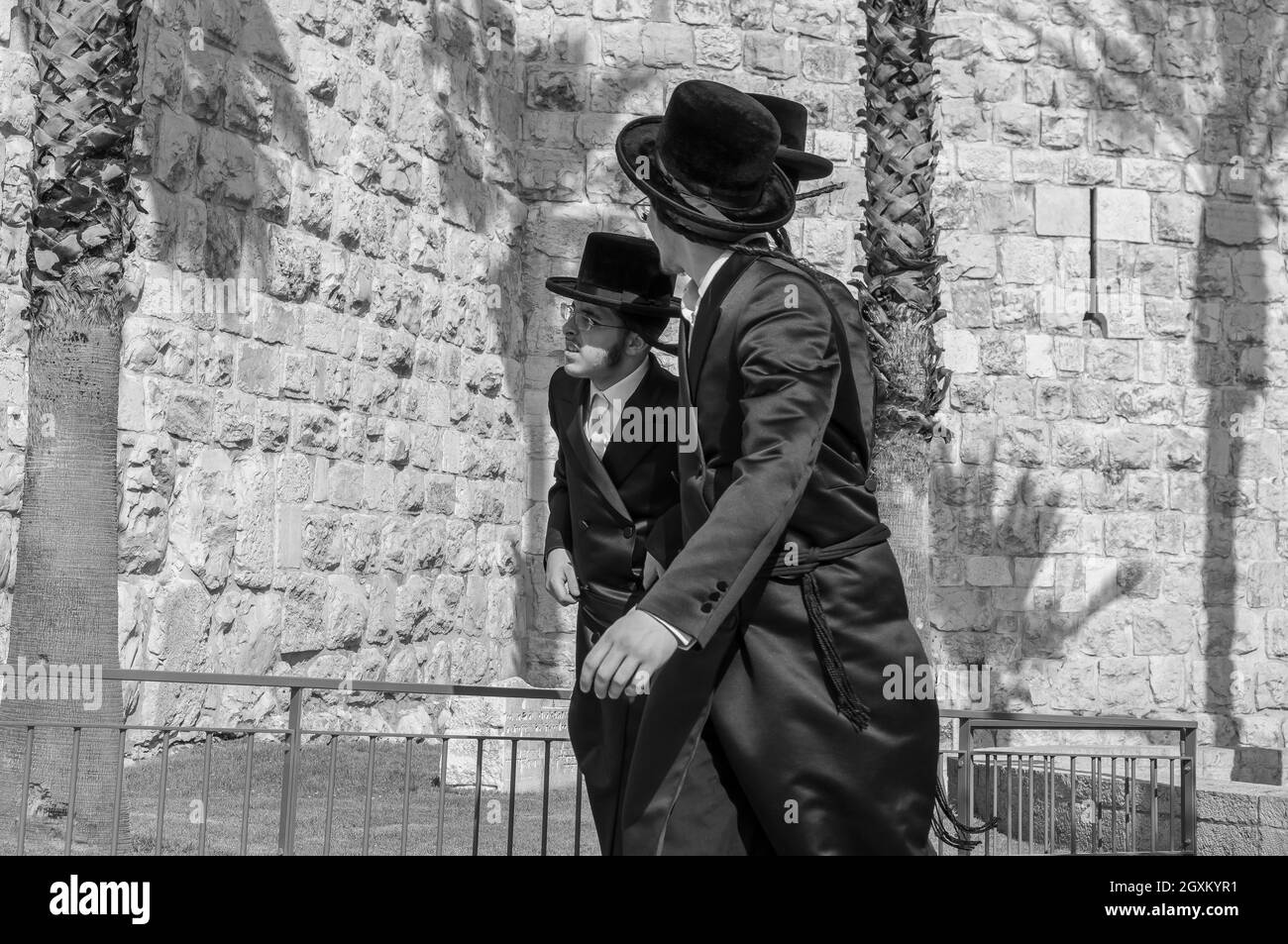 Orthodox Jewish family in traditional clothing on the street of the old ...
