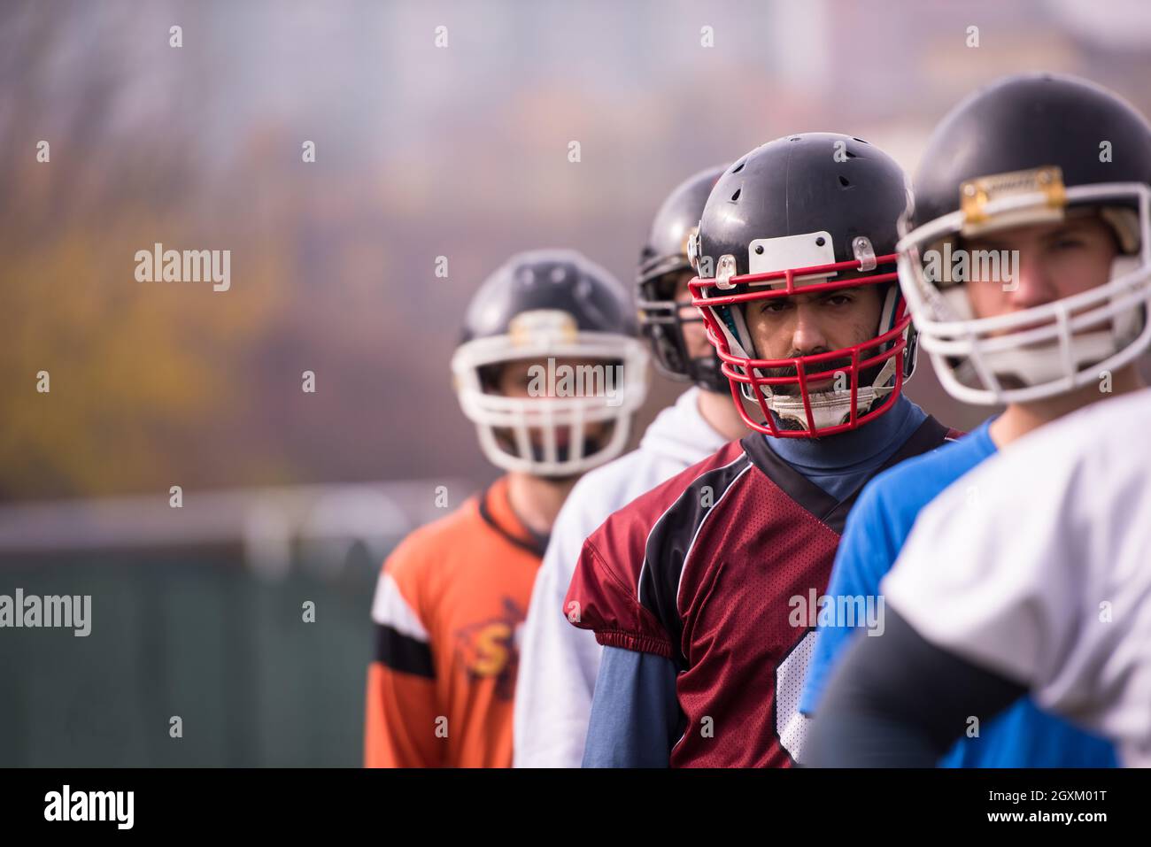 portrait of young american football team standing one behind the other ...