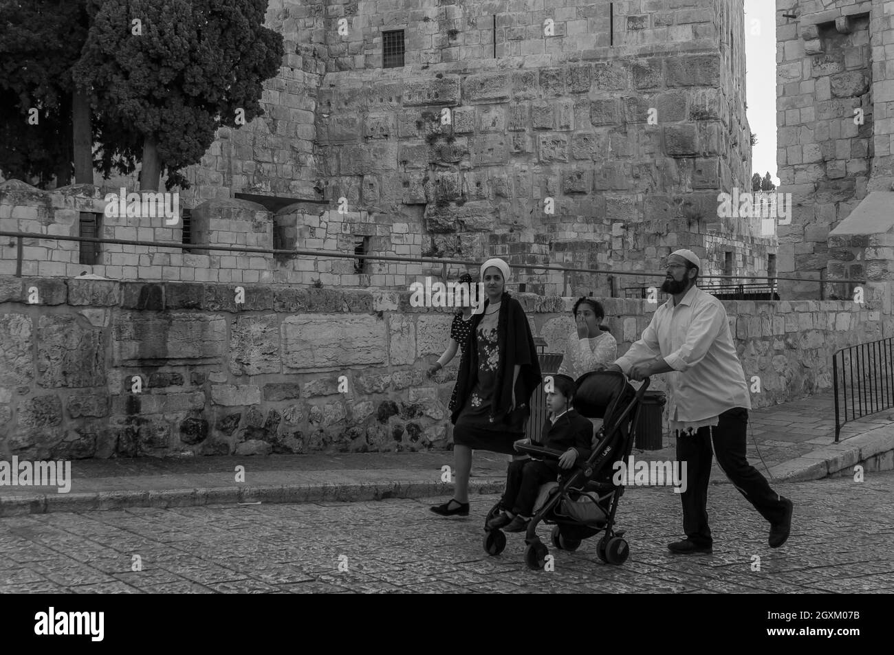 Orthodox Jewish family in traditional clothing on the street of the old ...