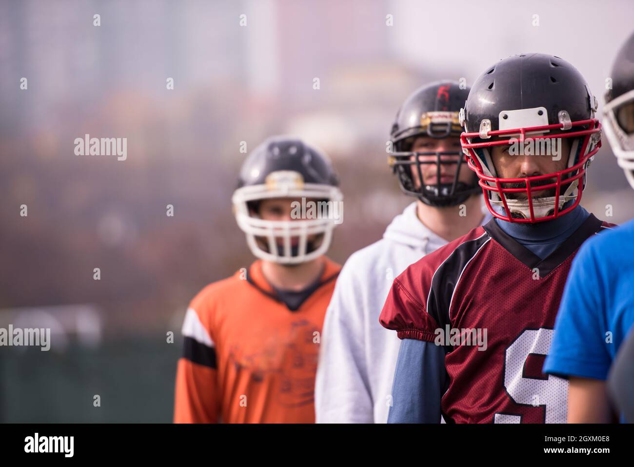 portrait of young american football team standing one behind the other ...