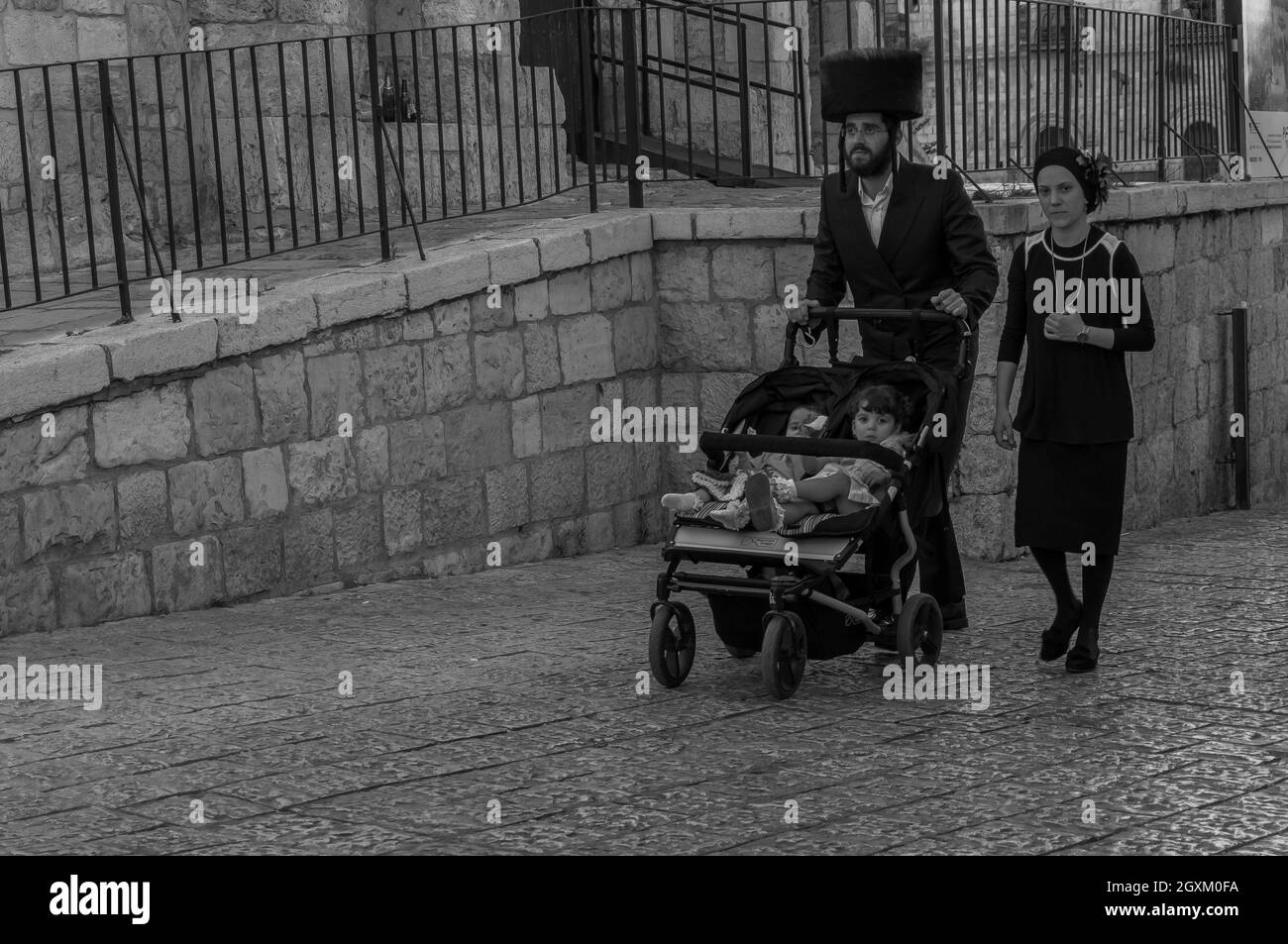 Orthodox Jewish family in traditional clothing on the street of the old ...