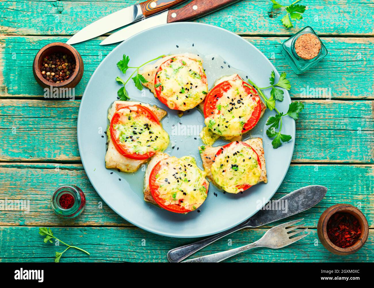 Baked fish with cheese and tomato.Roasted pangasius on wooden ...