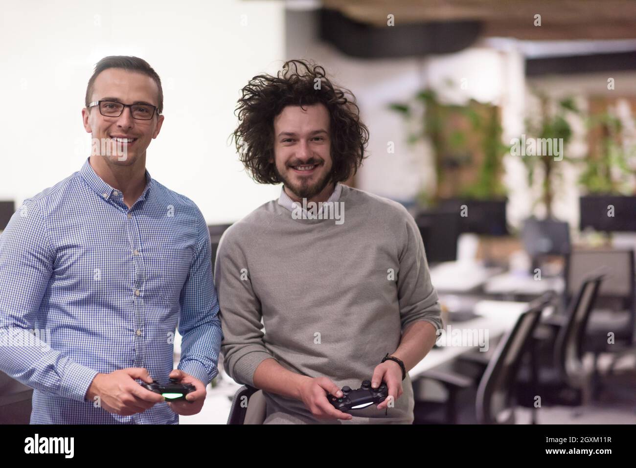 Work hard play hard. Workers Playing computer games in creative startup ...
