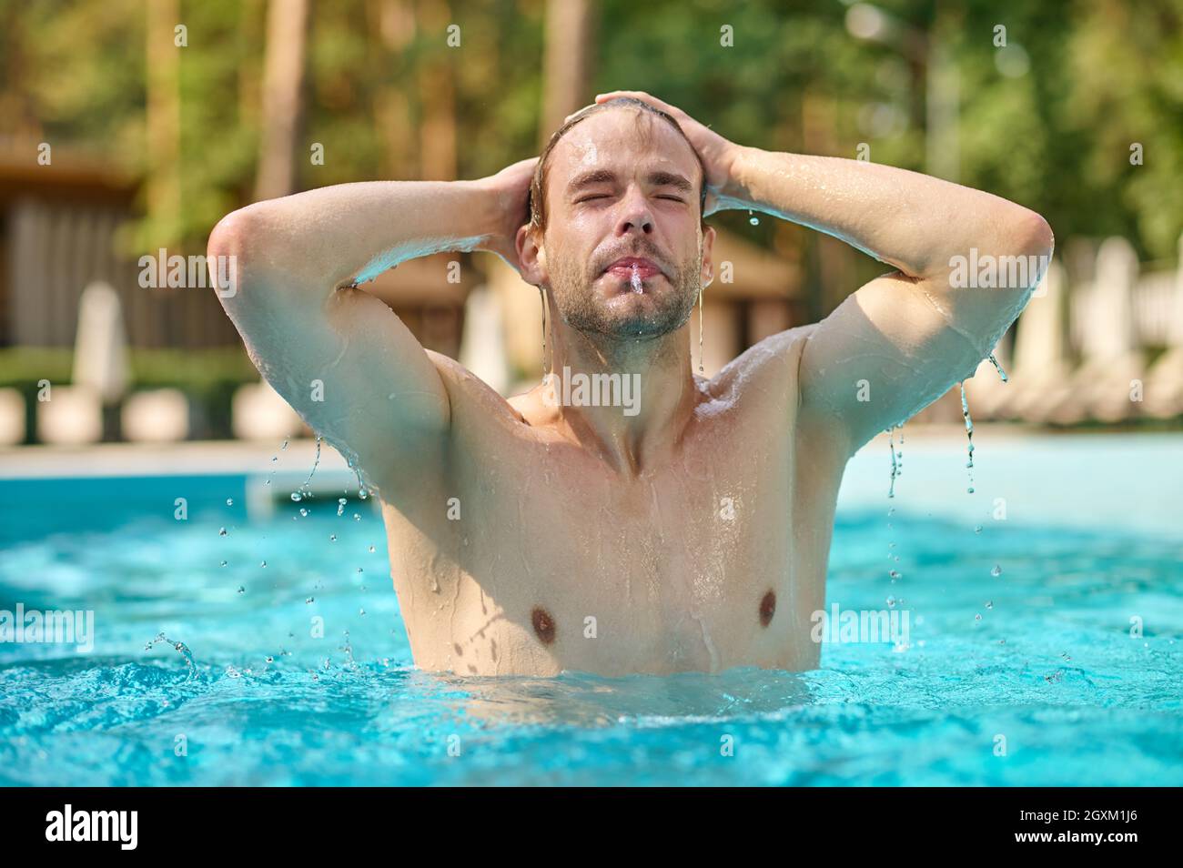 A picture of a young handsome man in a swimming pool Stock Photo - Alamy