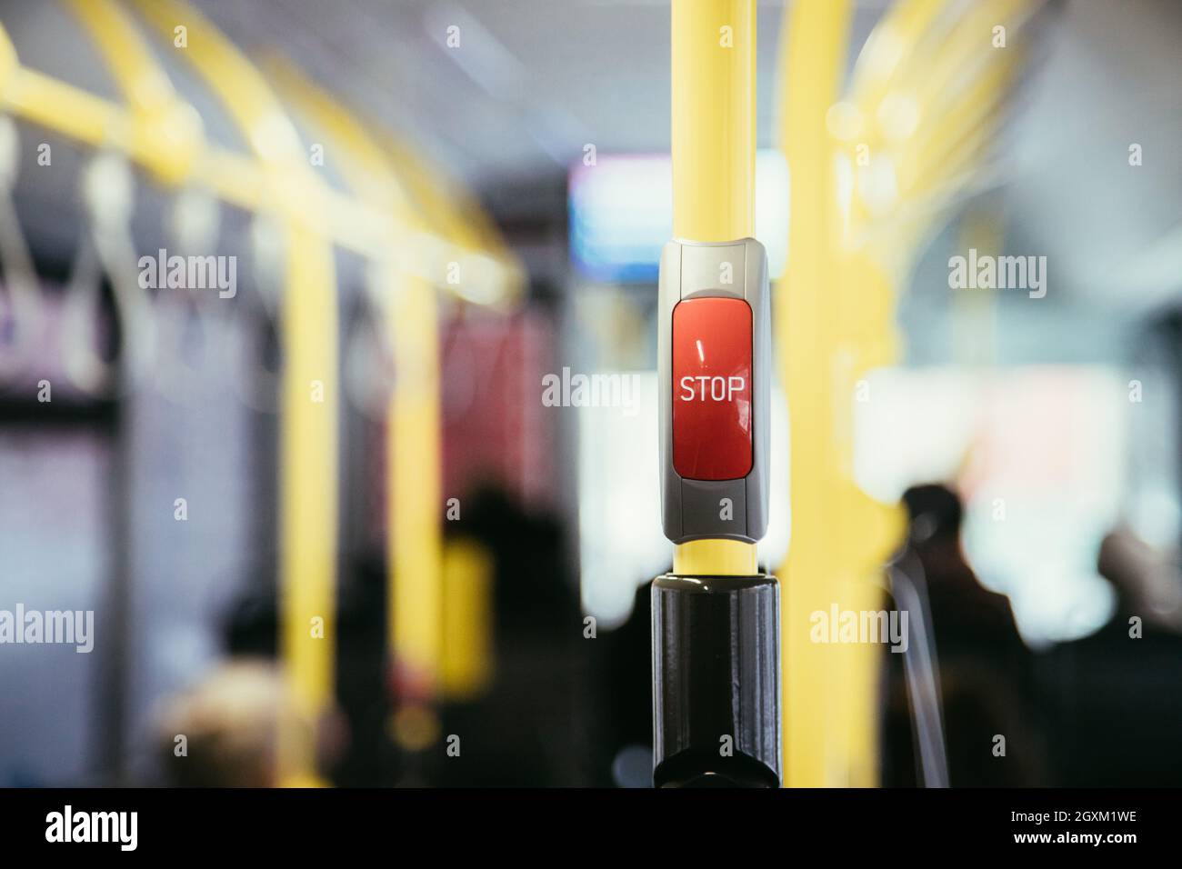 Stop Button in a bus, public transport, blurry Stock Photo - Alamy