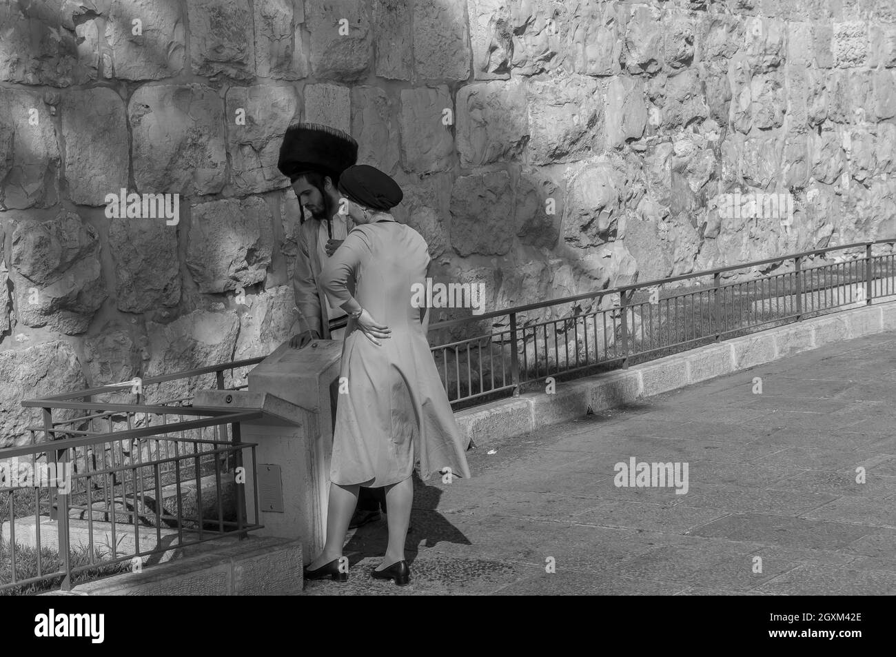 Orthodox Jewish family in traditional clothing on the street of the old ...