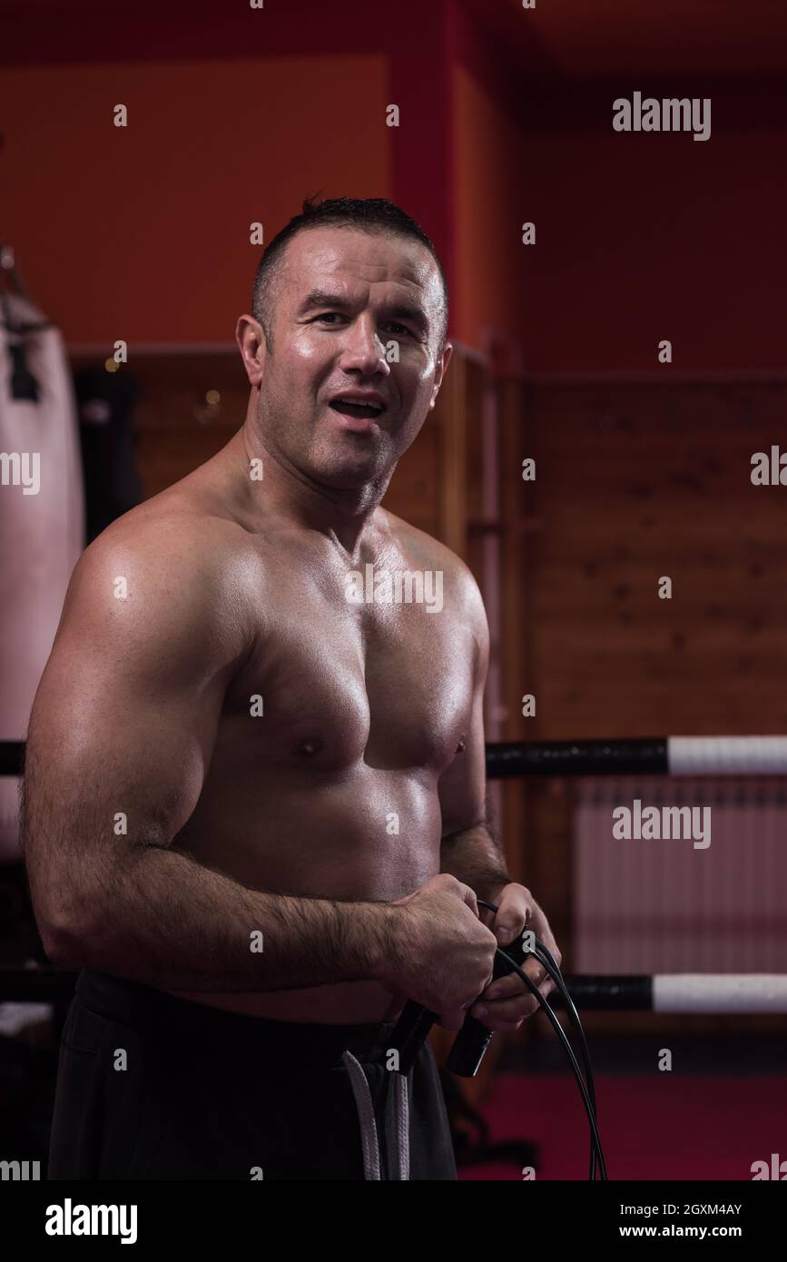 portrait of muscular professional kickboxer who standing in the ring ...
