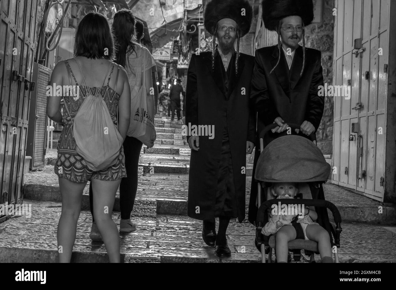 Orthodox Jewish family in traditional clothing on the street of the old ...