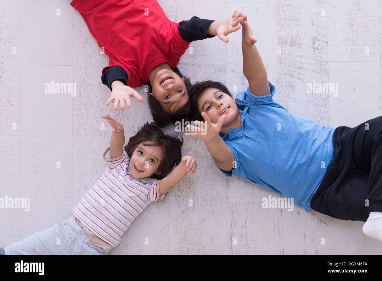 happy young boys having fun on the floor in a new modern home Stock Photo - Alamy