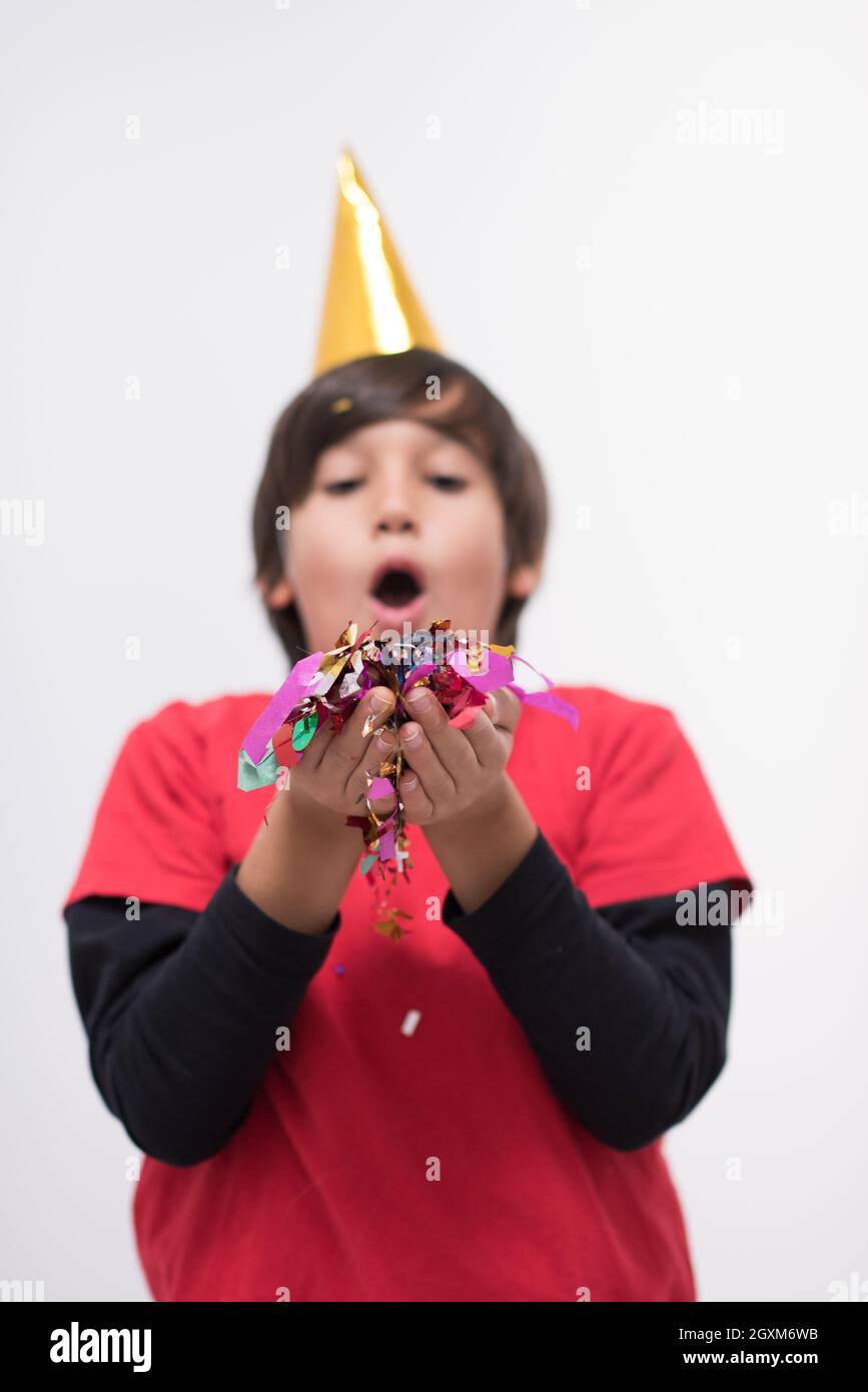 Happy kid celebrating party with blowing confetti Stock Photo - Alamy