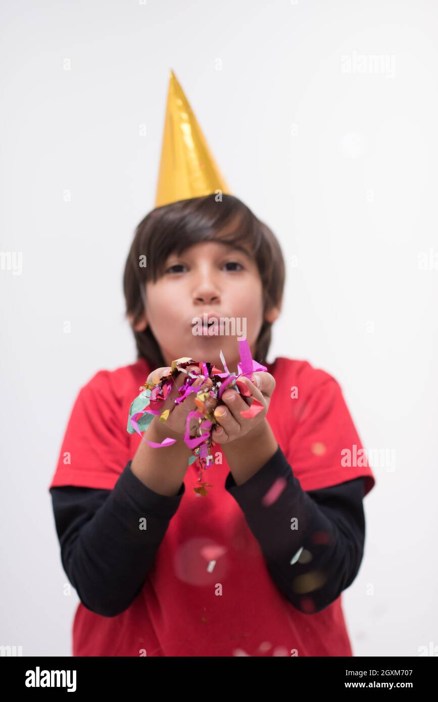 Happy kid celebrating party with blowing confetti Stock Photo - Alamy