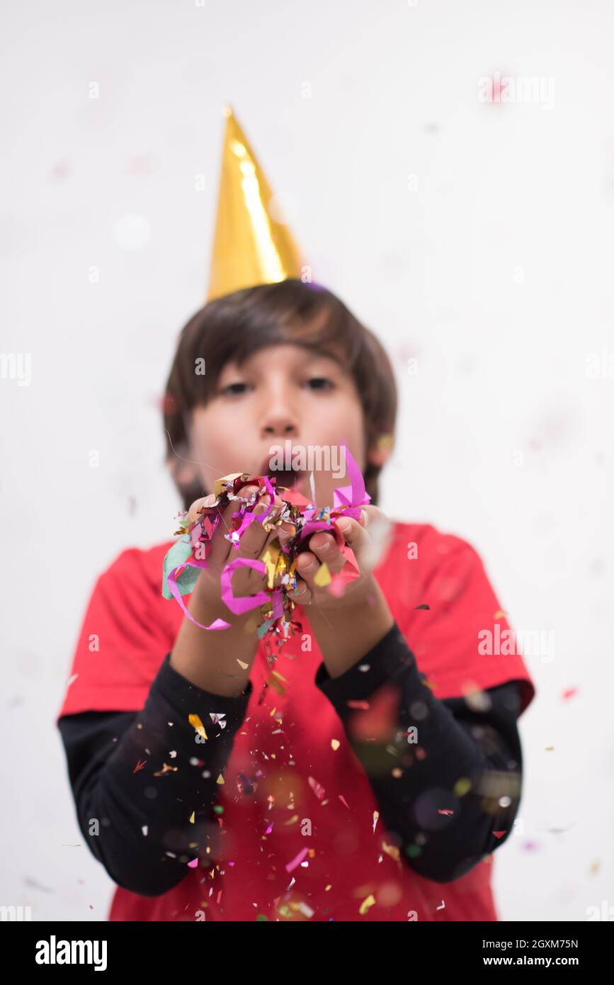 Happy kid celebrating party with blowing confetti Stock Photo - Alamy