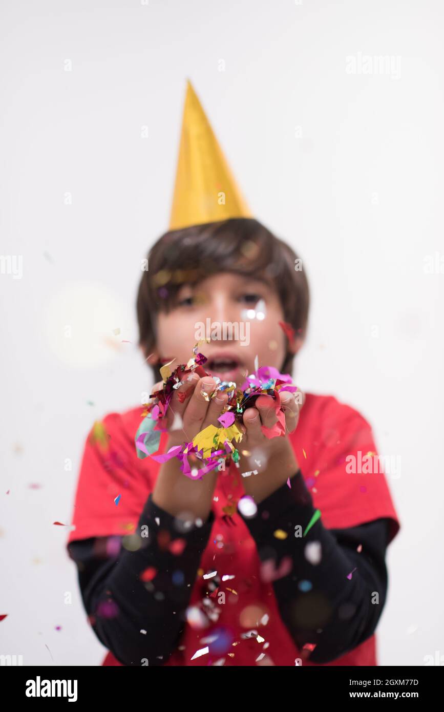 Happy kid celebrating party with blowing confetti Stock Photo - Alamy