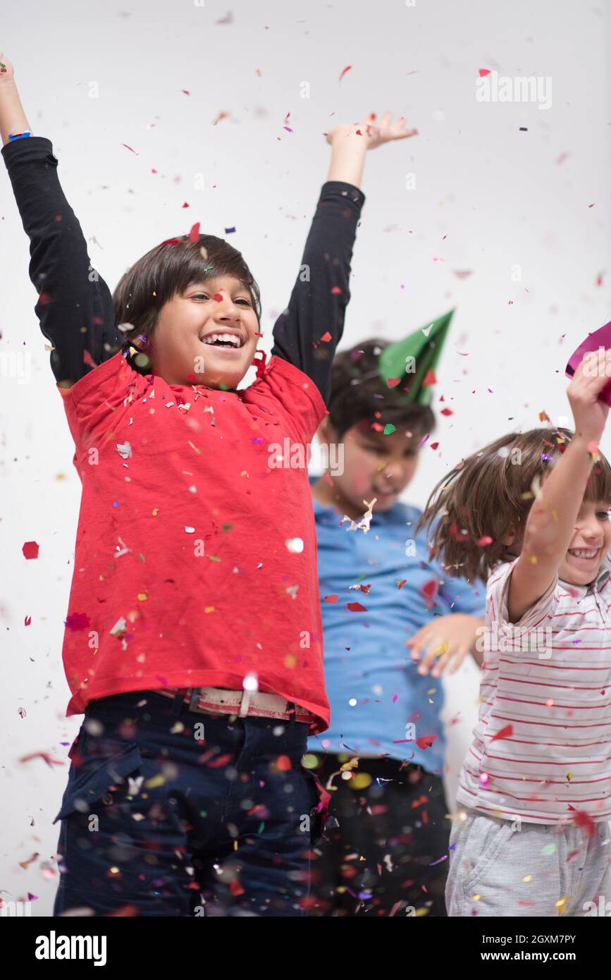 Happy kids celebrating party with blowing confetti Stock Photo - Alamy