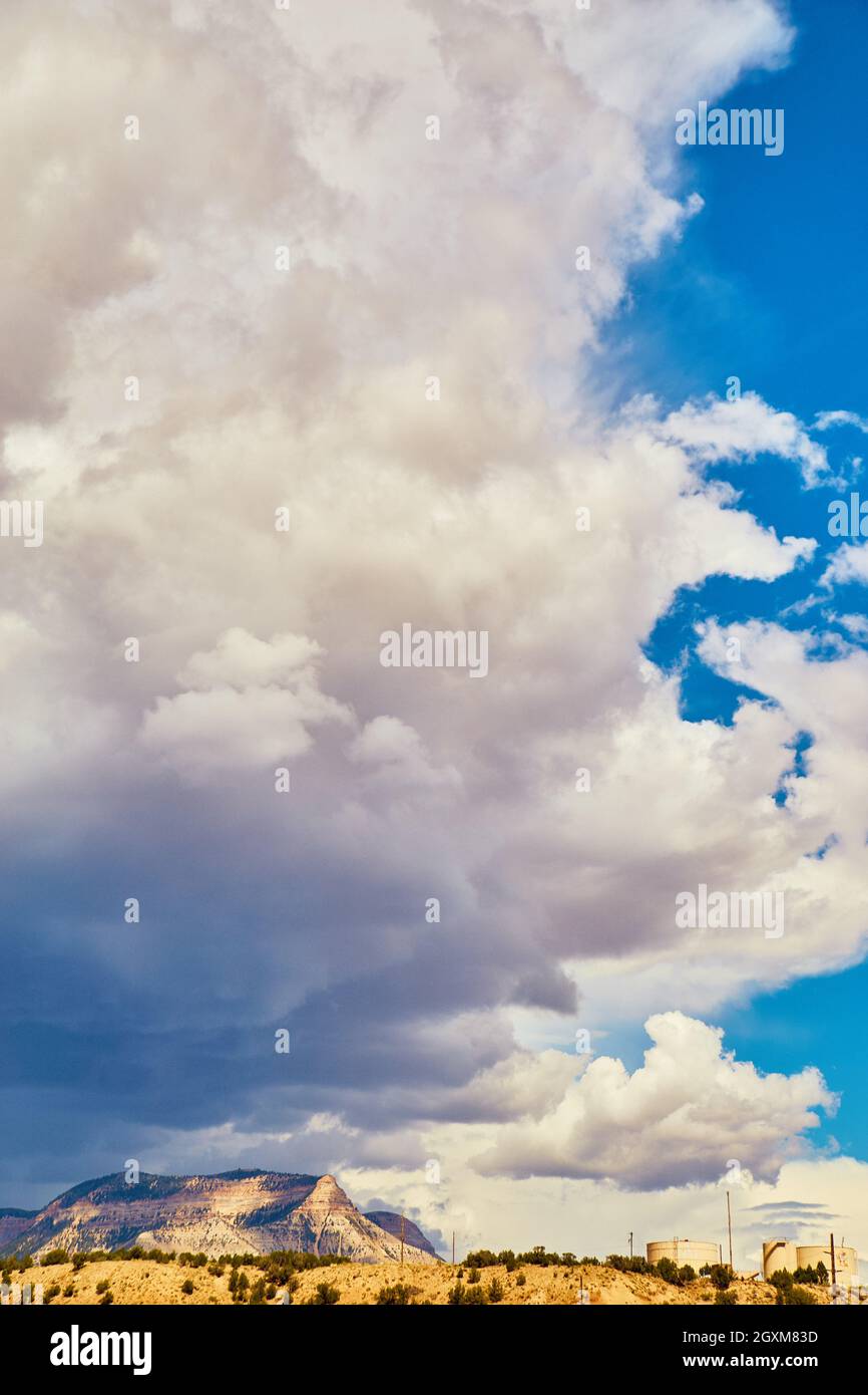 Vertical landscape of desert mountains with large storm clouds looming ...