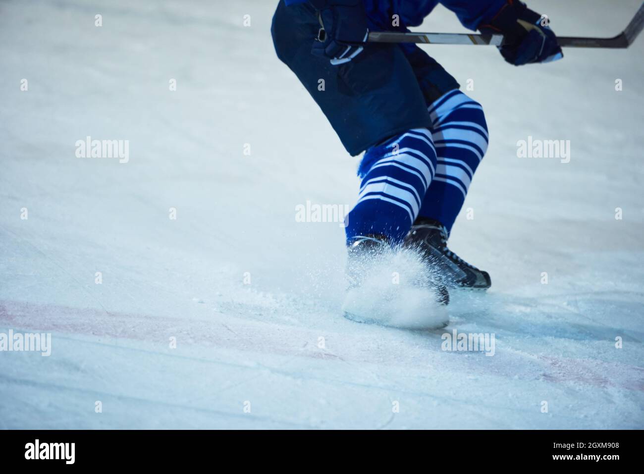ice hockey player in action kicking with stick Stock Photo - Alamy