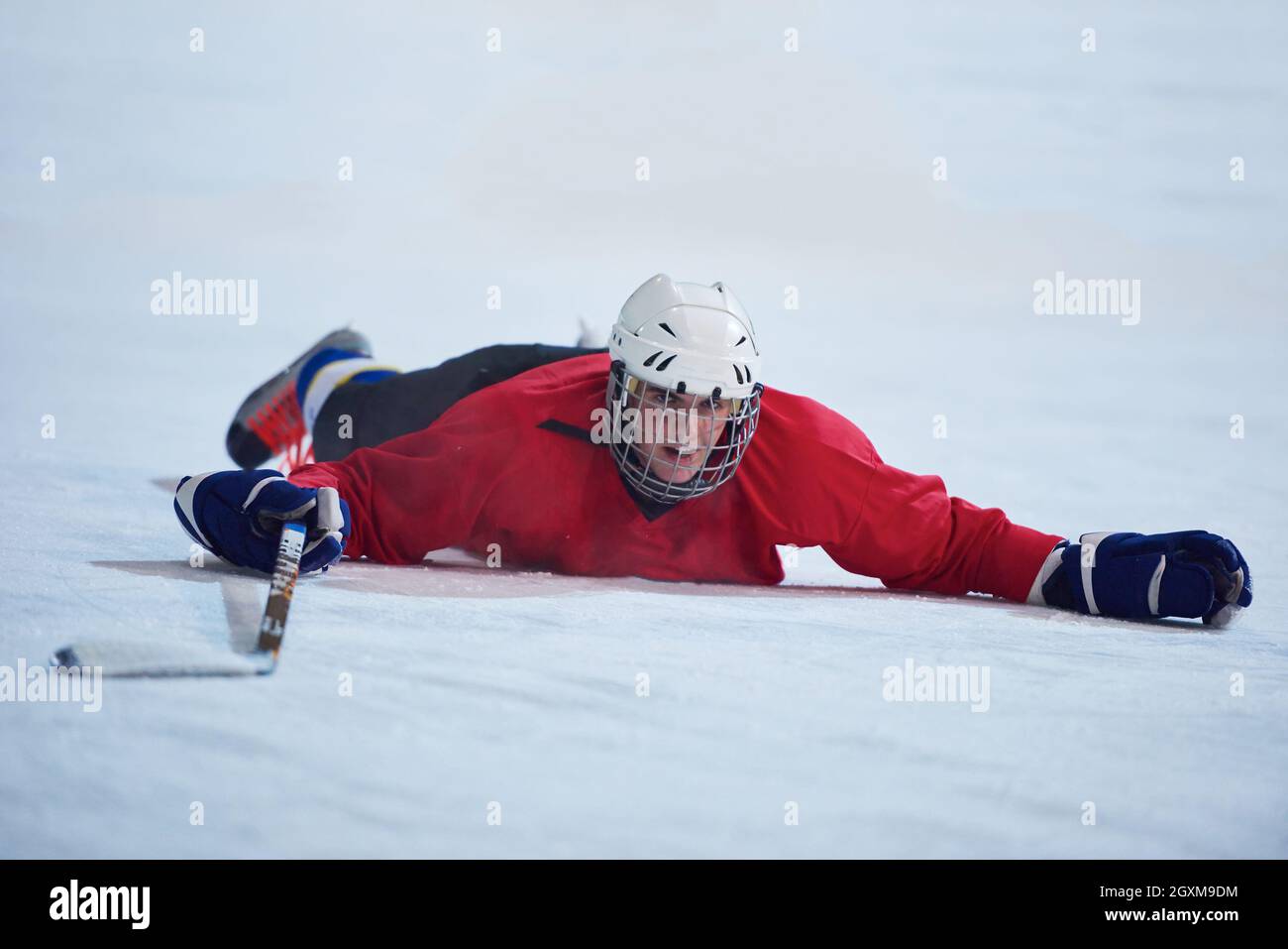 ice hockey player in action kicking with stick Stock Photo - Alamy