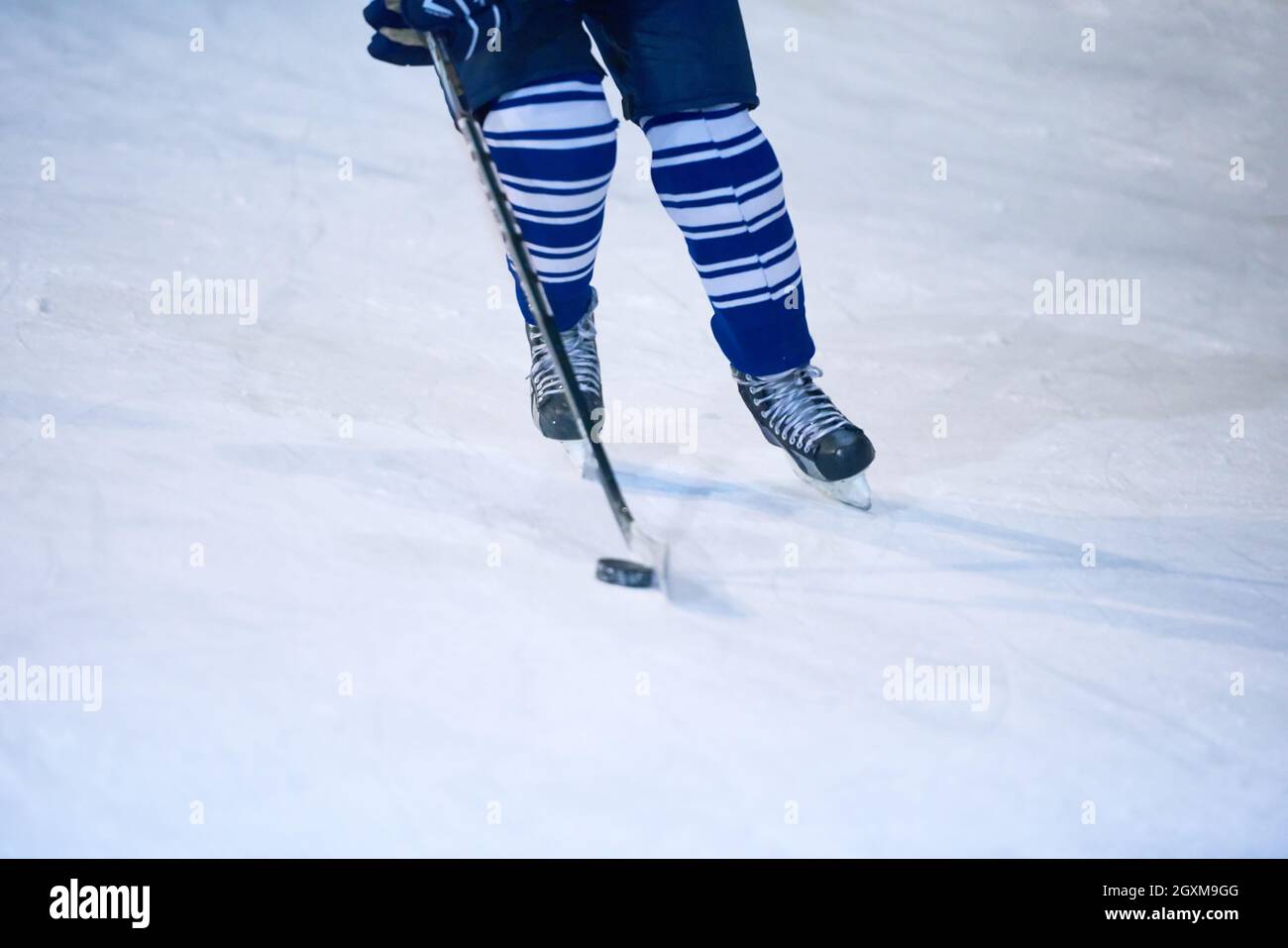 ice hockey player in action kicking with stick Stock Photo - Alamy