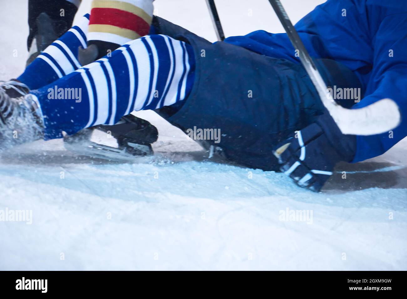 ice hockey player in action kicking with stick Stock Photo - Alamy