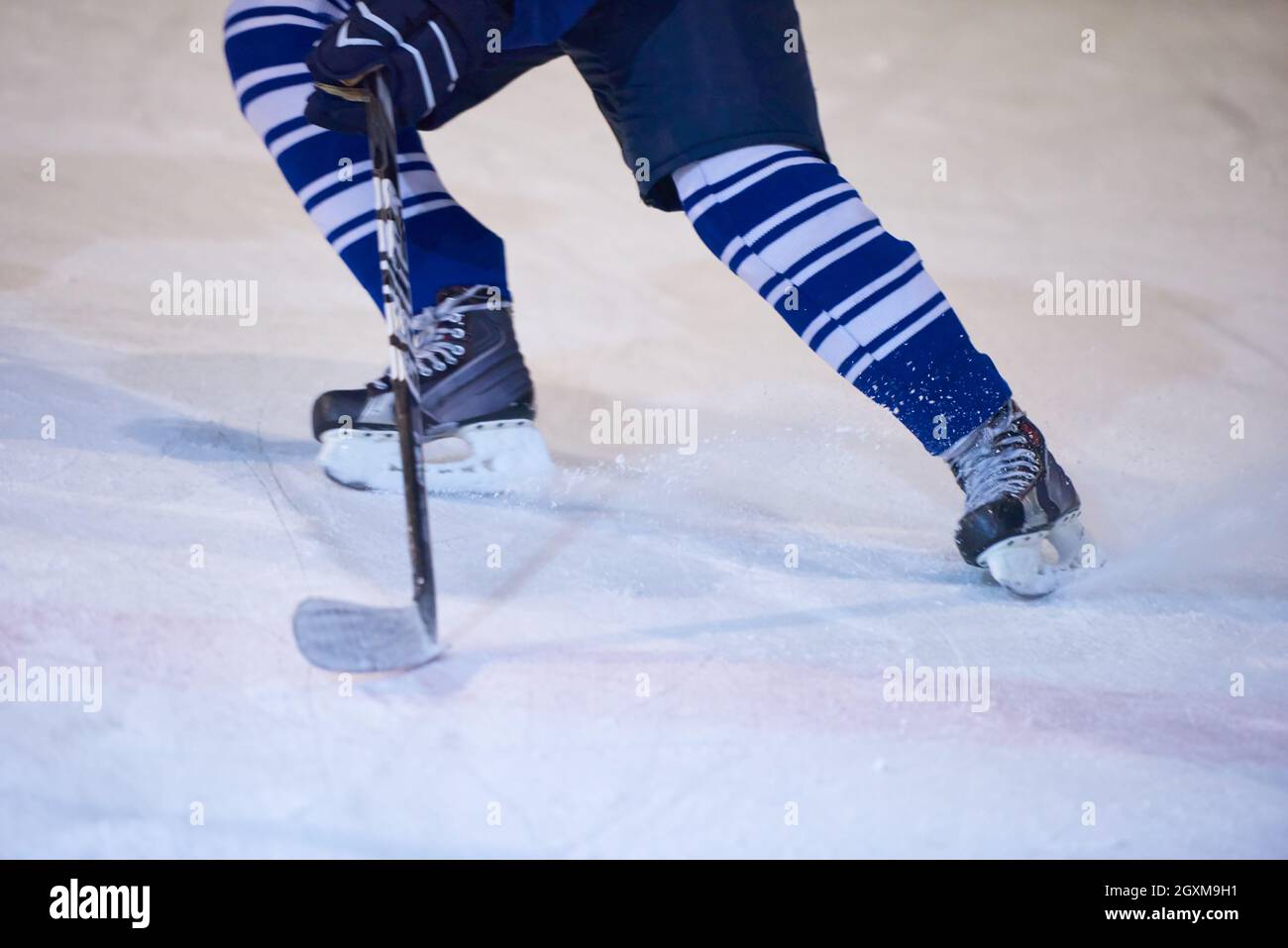 ice hockey player in action kicking with stick Stock Photo - Alamy