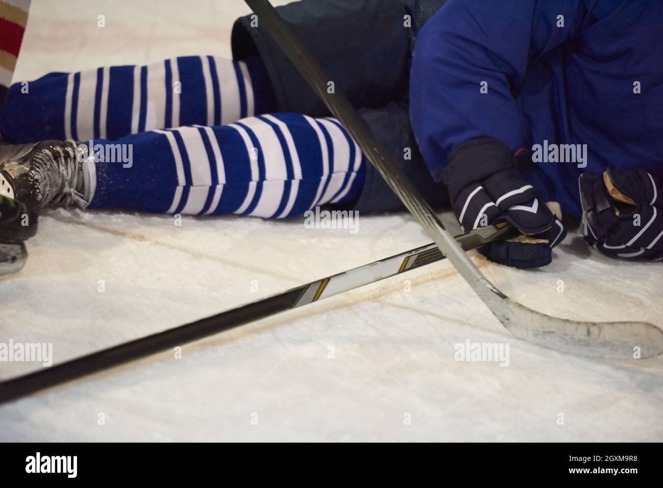 ice hockey player in action kicking with stick Stock Photo - Alamy