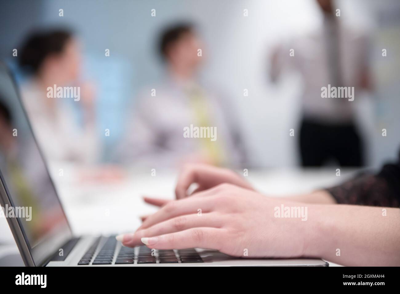 business woman hands typing on laptop computer on meeting, blurred ...