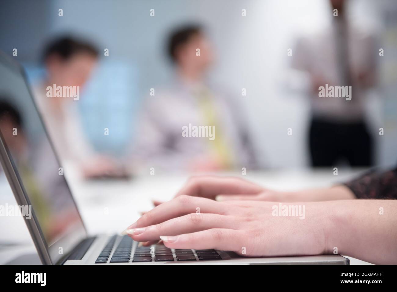 business woman hands typing on laptop computer on meeting, blurred ...