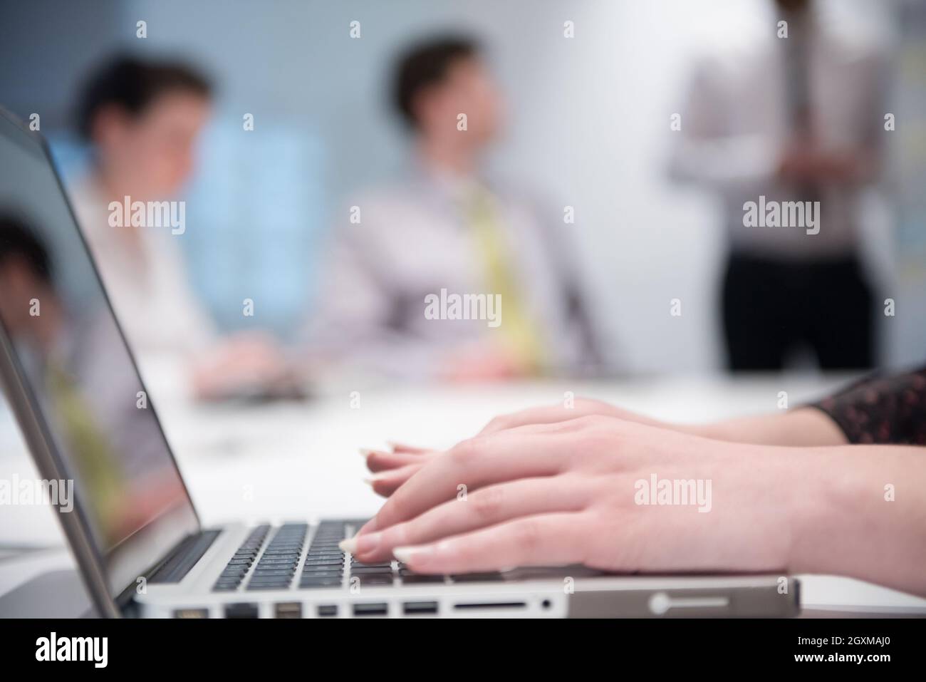 business woman hands typing on laptop computer on meeting, blurred ...