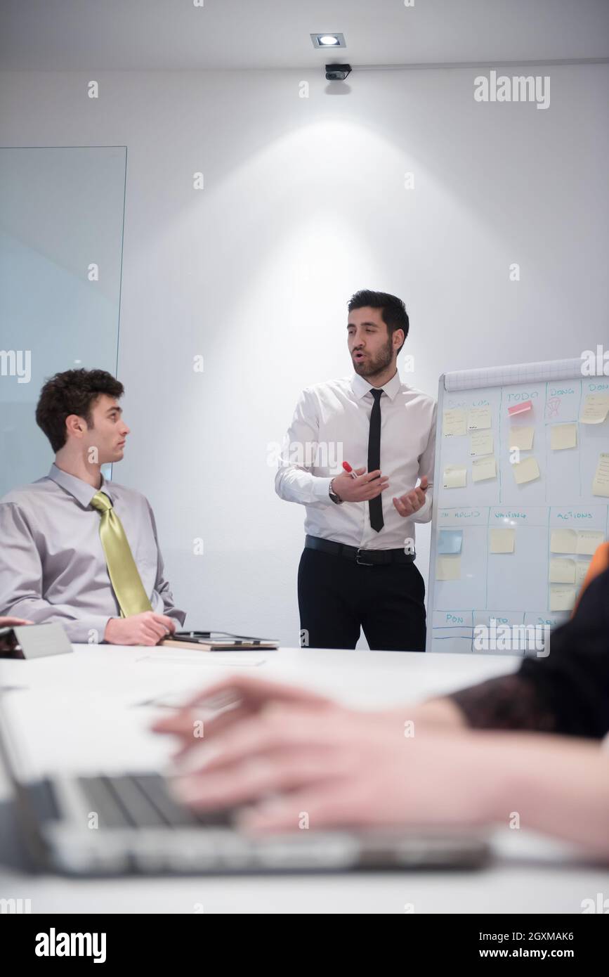 young business woman on meeting usineg laptop computer, blured group of ...