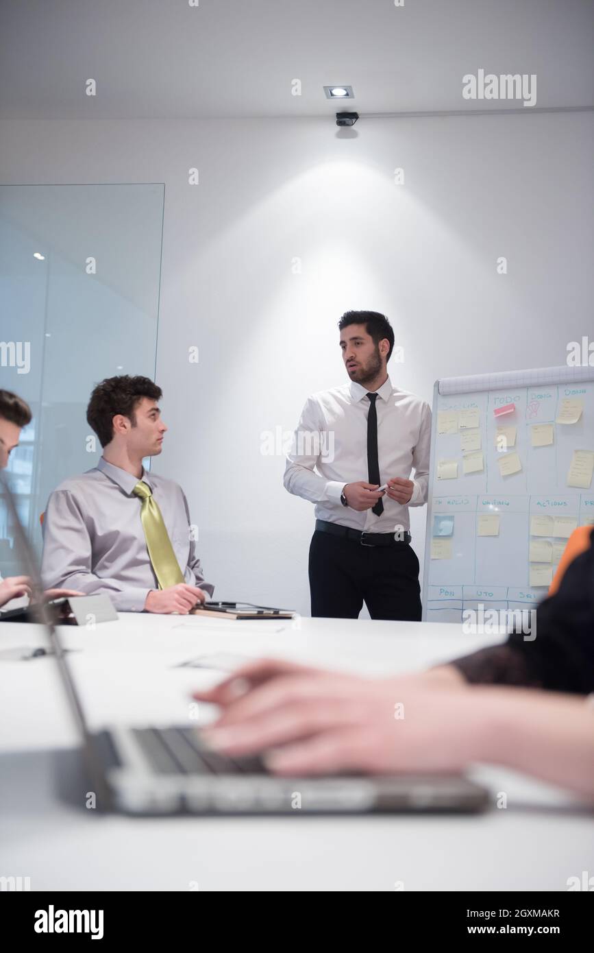 young business woman on meeting usineg laptop computer, blured group of ...