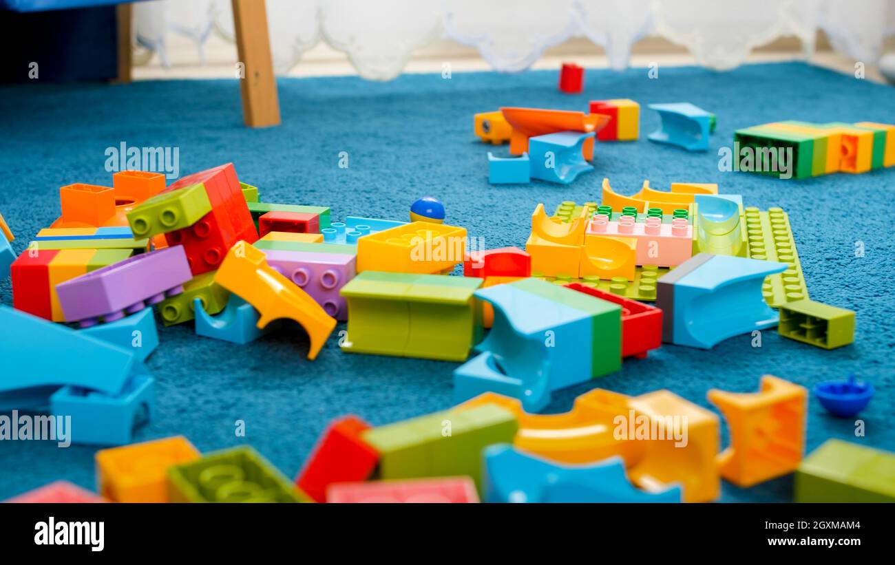 Closeup image of messy floor in playroom covered with colorful toy ...